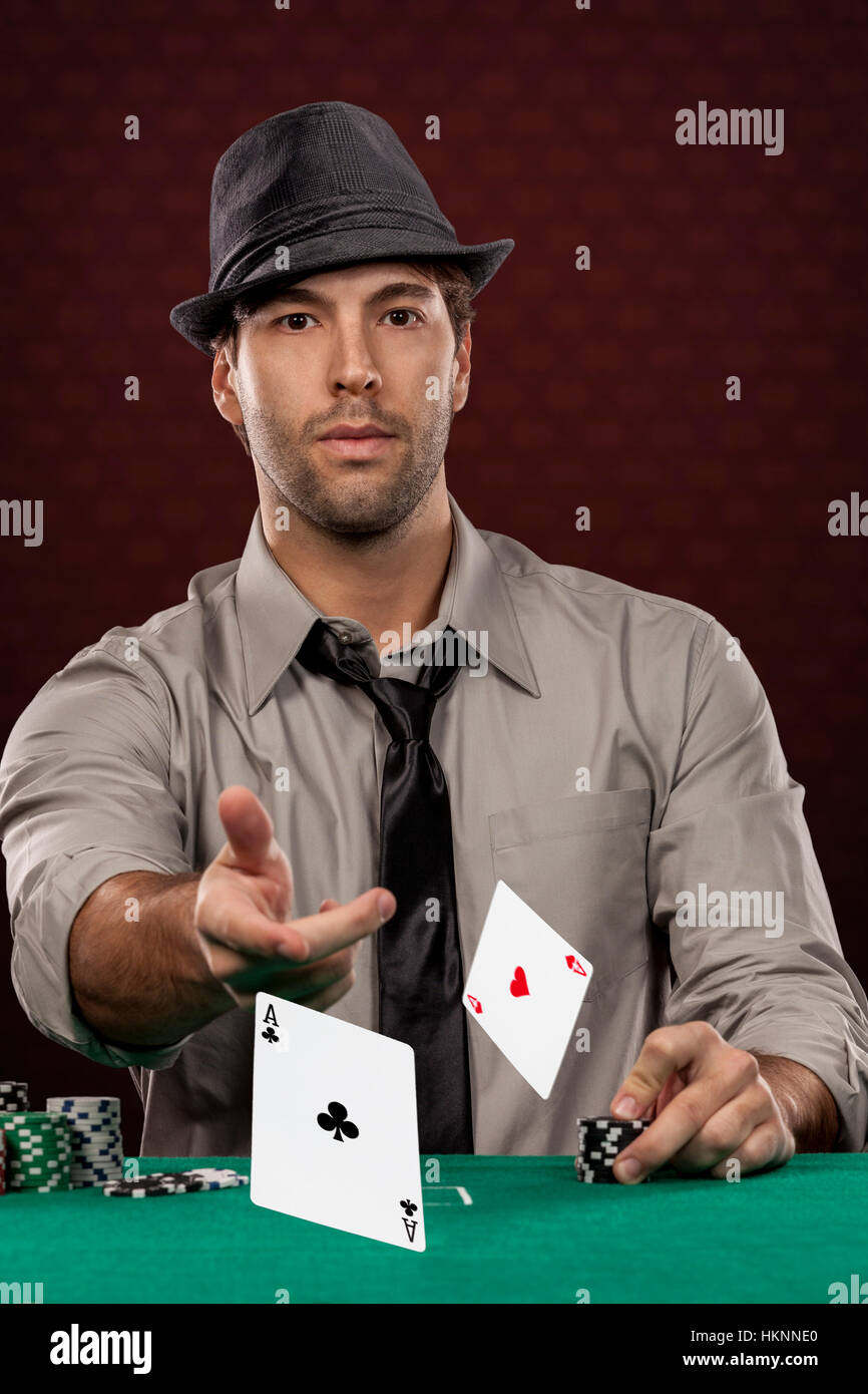 Poker player, on a red background, throwing two ace cards Stock Photo ...