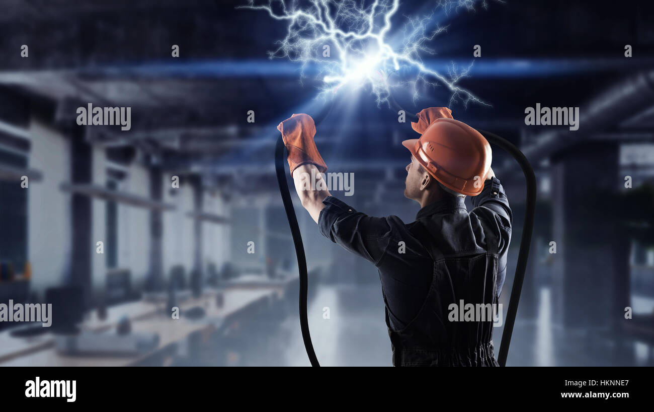 Electrician man joining cable presenting power and energy concept ...
