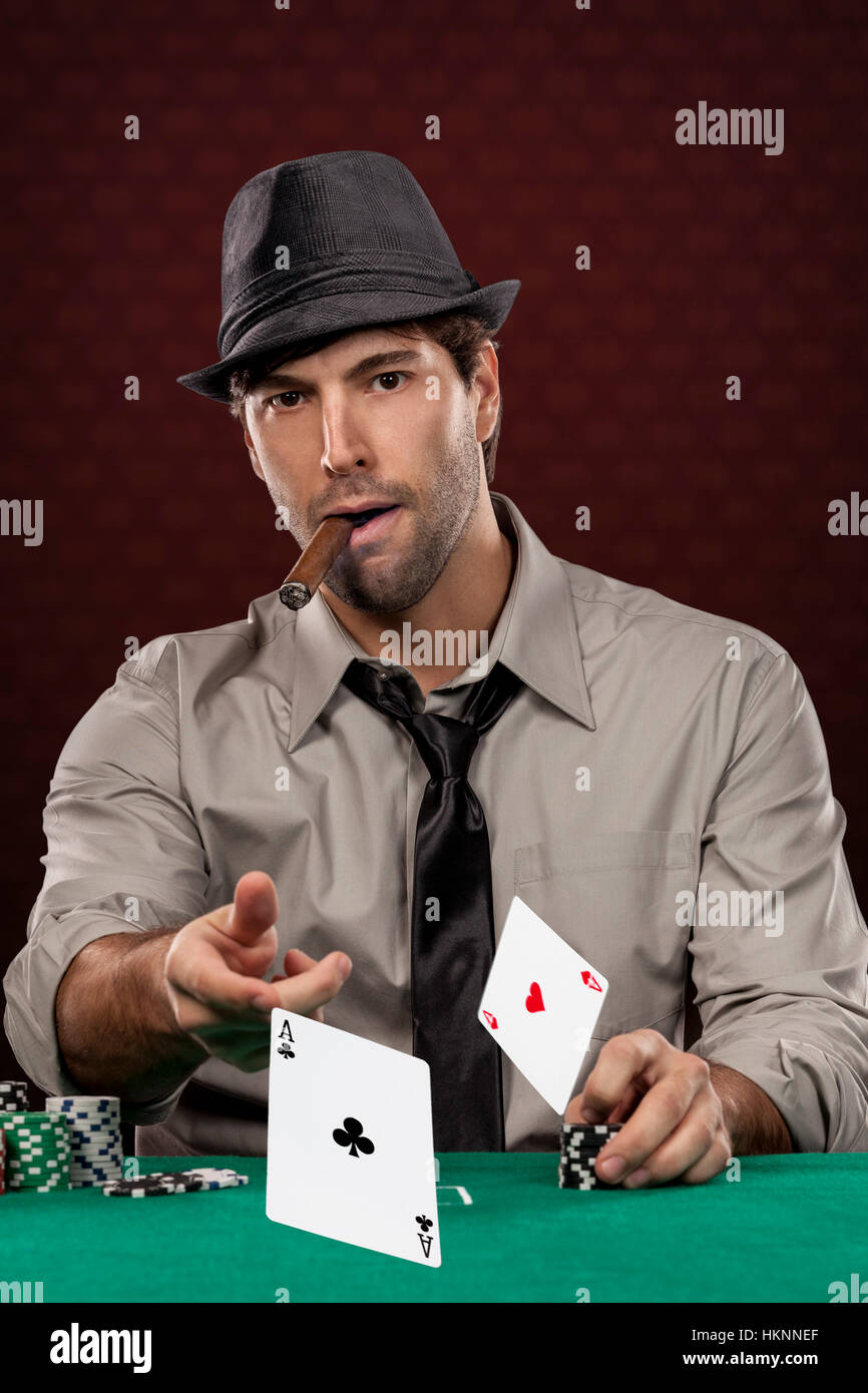 Poker player, on a red background, throwing two ace cards Stock Photo ...