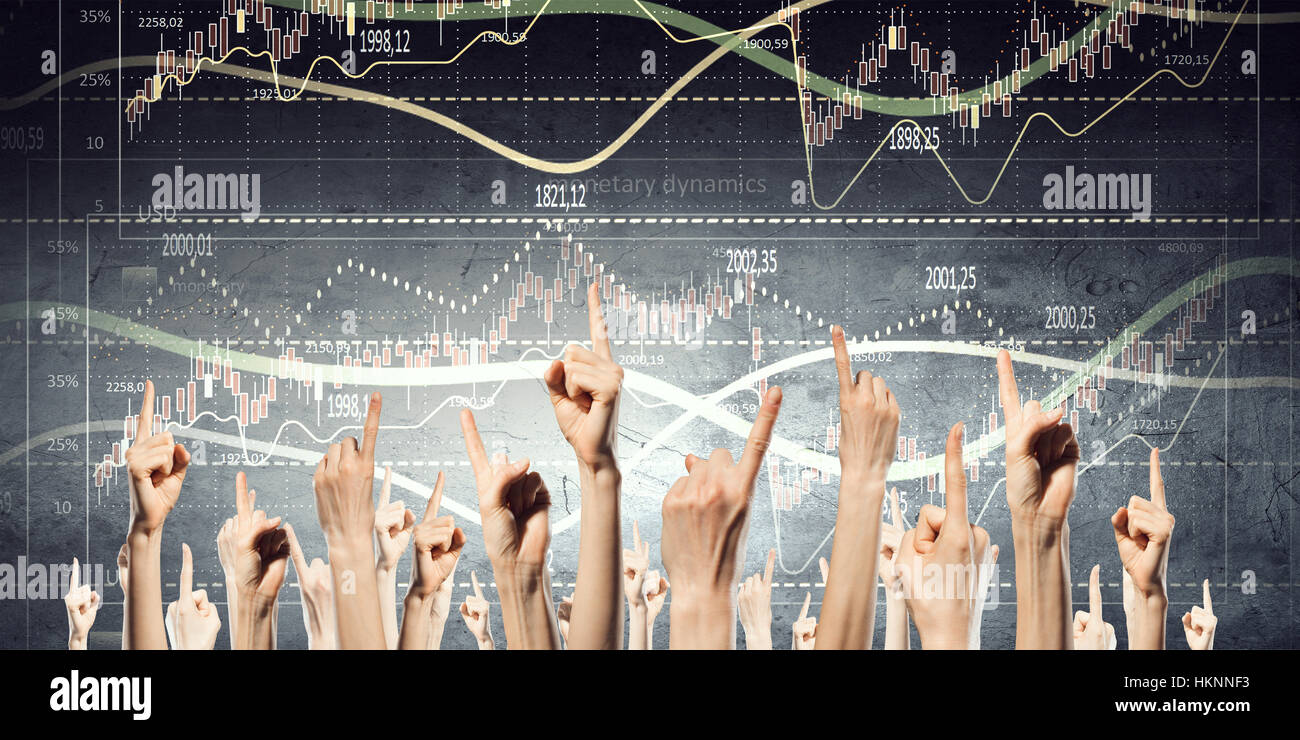 Row of raised hands showing different gestures and graphs at background ...