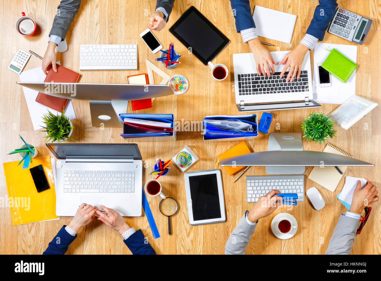 Top view of office table with four colleagues working together Stock ...