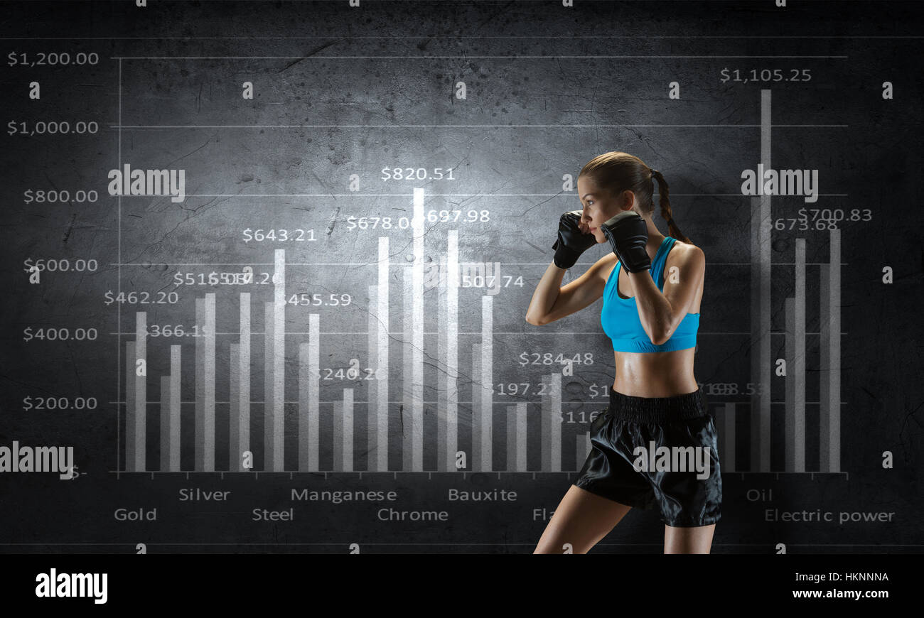 Young woman boxing against graphs background. Mixed media Stock Photo ...