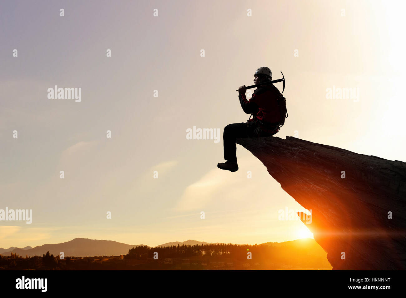 Young brave man alpinist sitting on cliff edge at night Stock Photo - Alamy