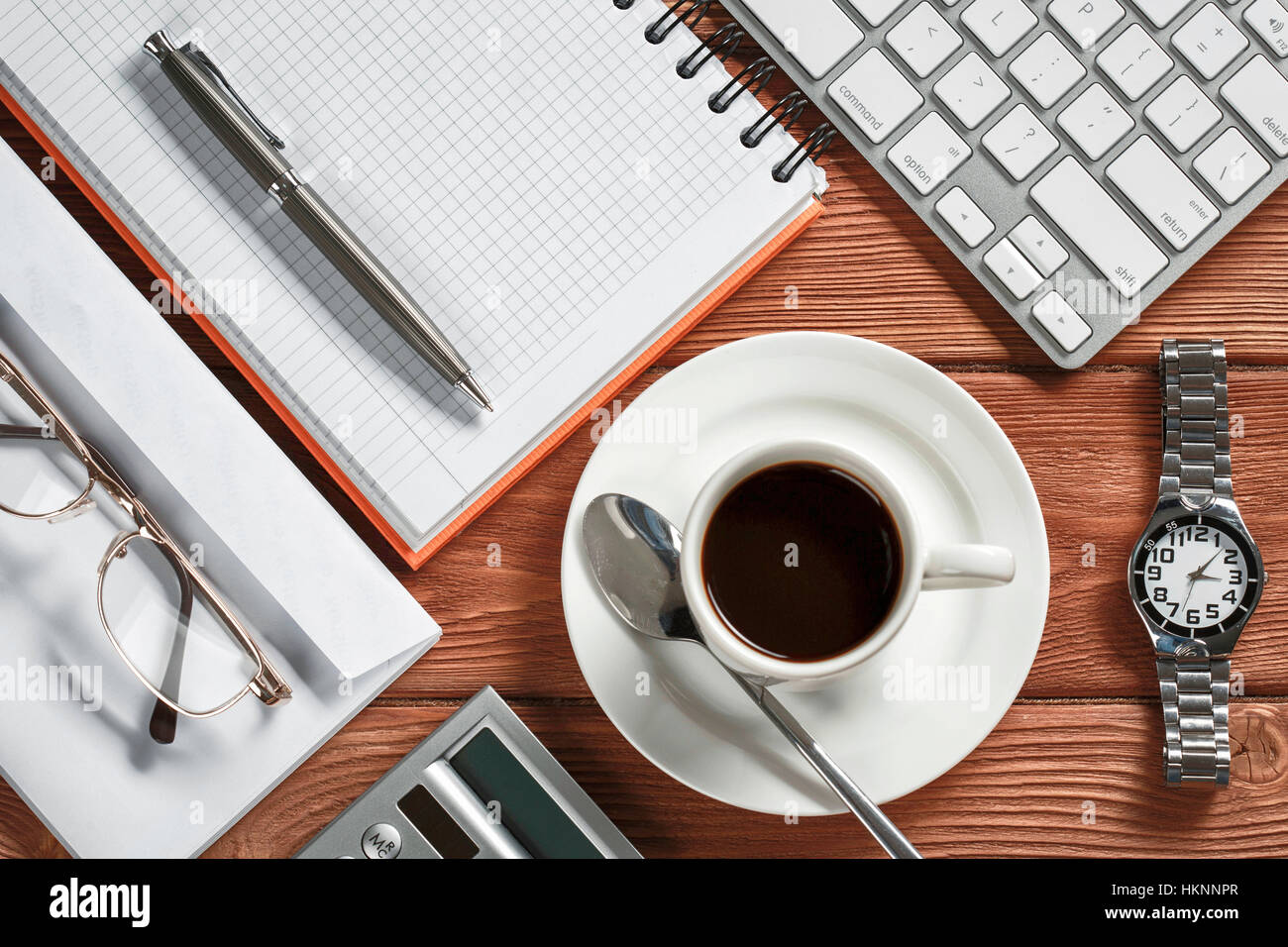 Top view of Office table with keyboard cup watch notebook and ...
