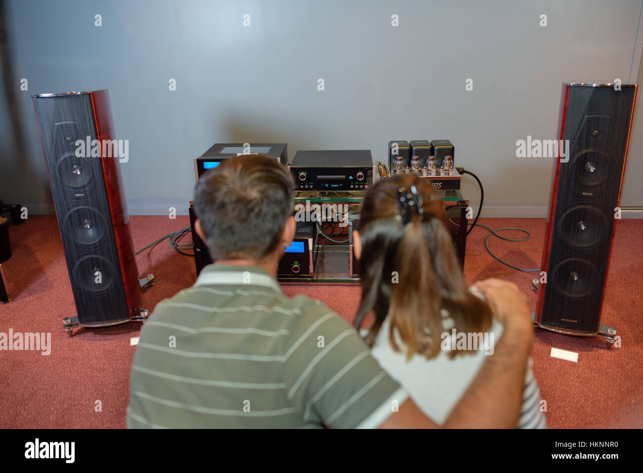 Couple looking at sound system Stock Photo - Alamy