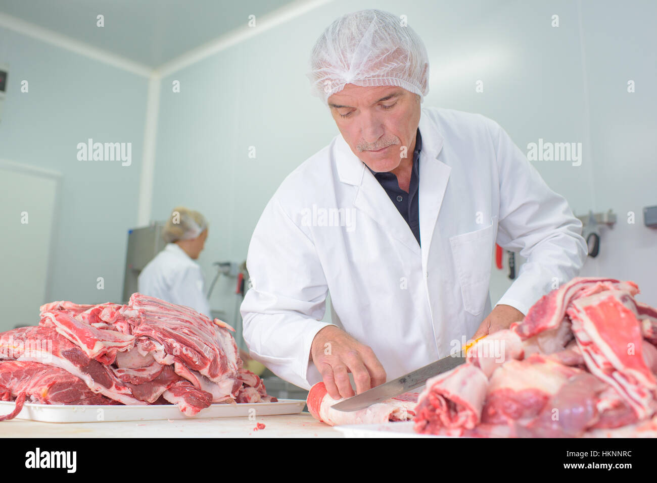 Butcher cutting up meat Stock Photo - Alamy