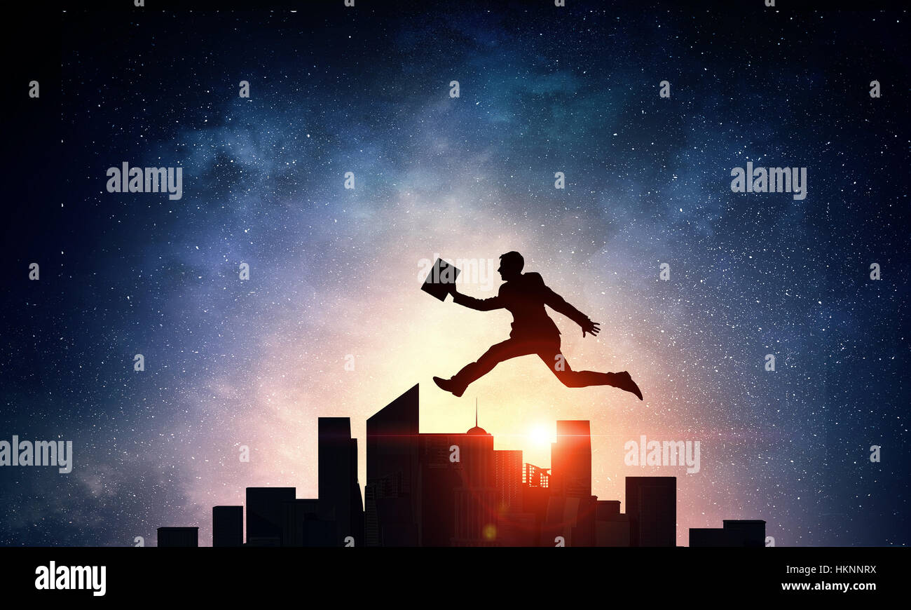 Silhouette businessman jumping over night hi-res stock photography and ...
