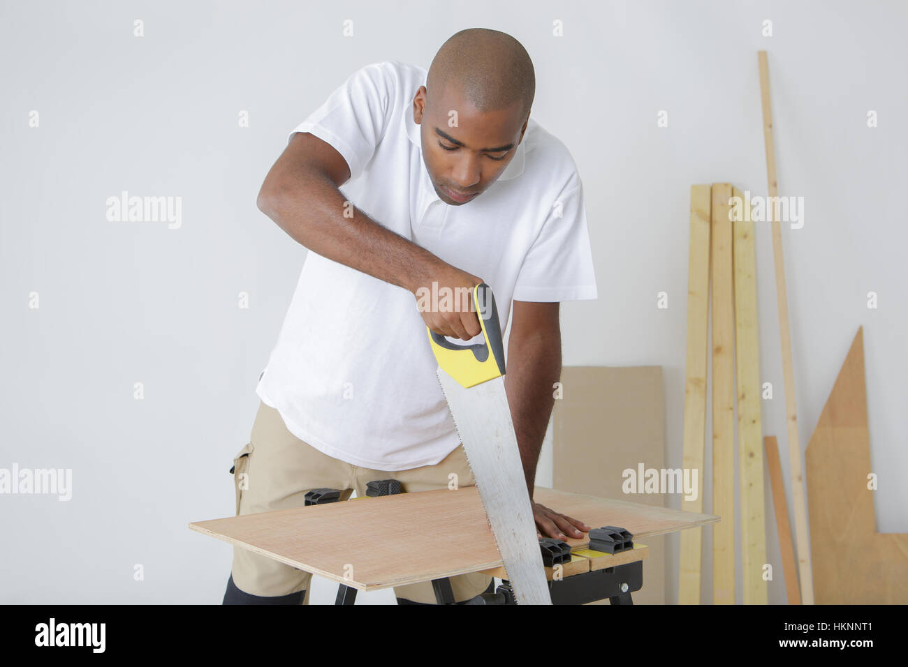 Man sawing wood Stock Photo - Alamy