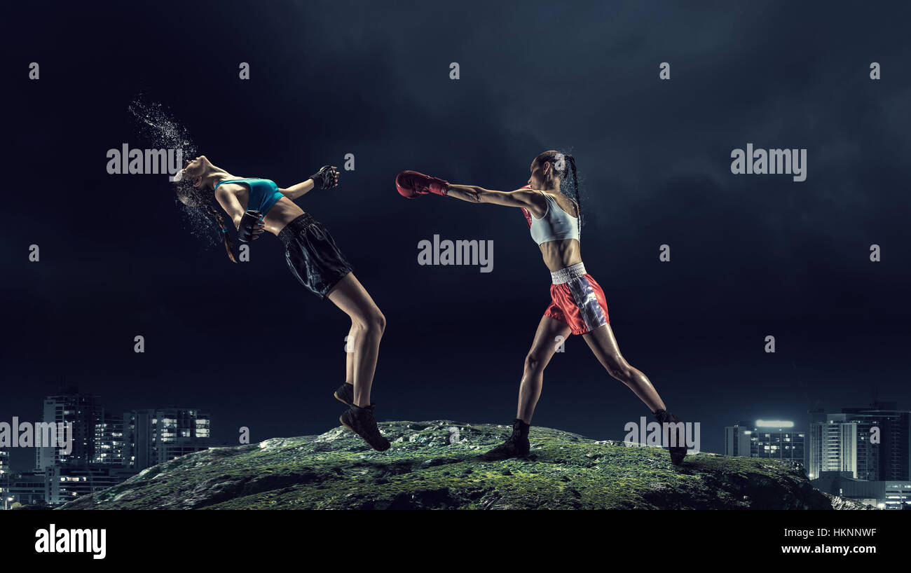 Two young pretty women boxing outdoor at night Stock Photo - Alamy