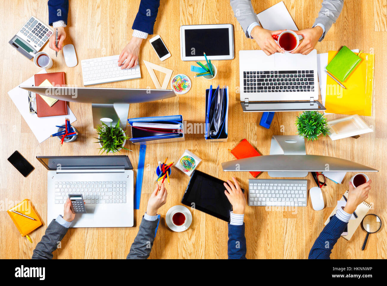 Top view of office table with four colleagues working together Stock ...