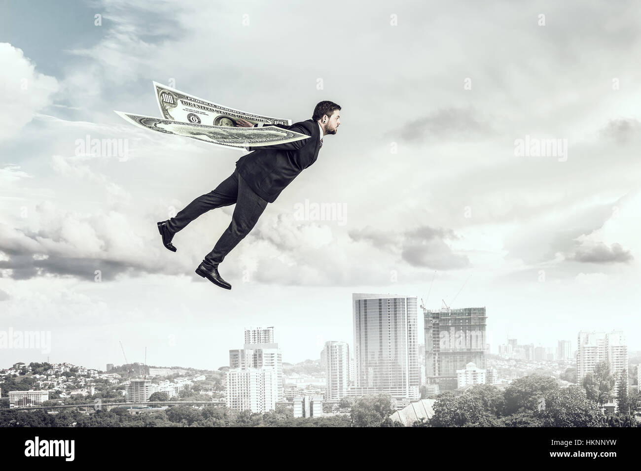 Businessman flying in sky with dollar bills wings Stock Photo - Alamy