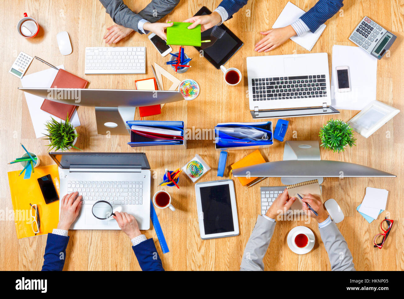 Top view of office table with four colleagues working together Stock ...