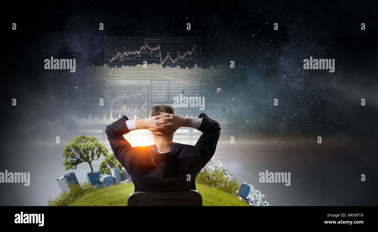 Back view of relaxed businessman sitting on chair with hands on nape ...