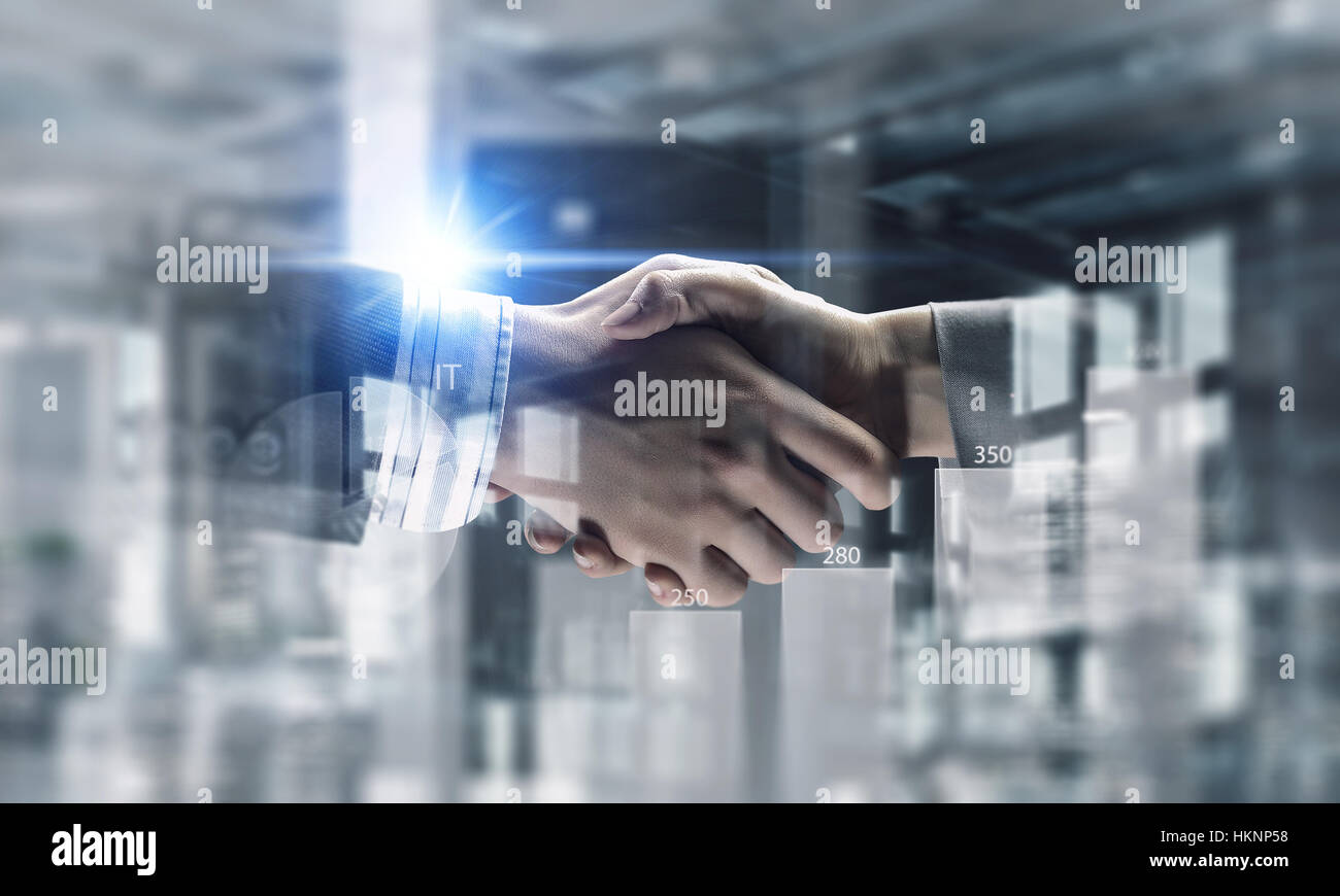 Close up of business handshake against office interior background ...