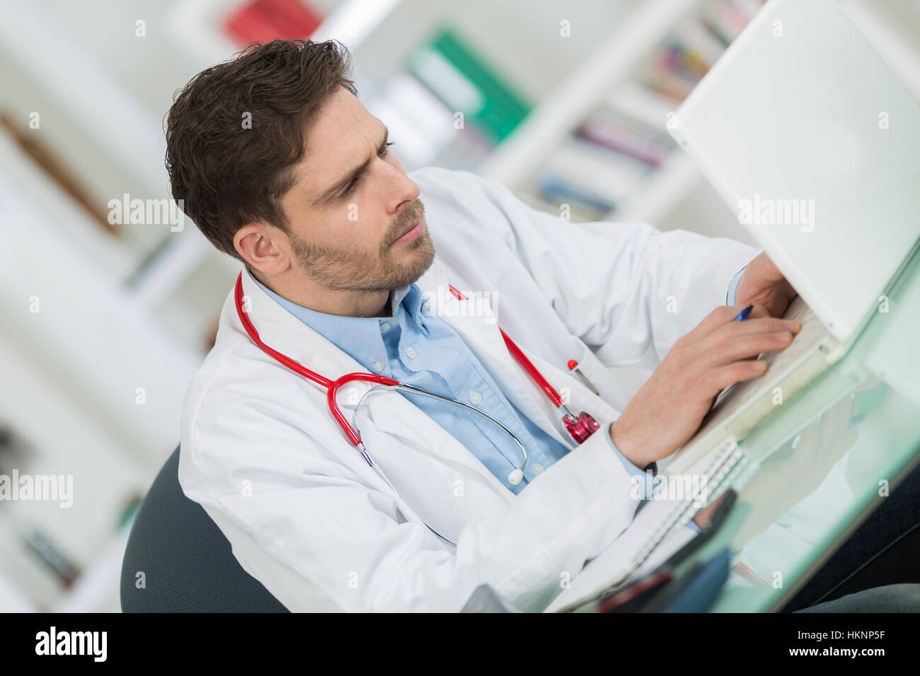 handsome young doctor at work in his office Stock Photo - Alamy