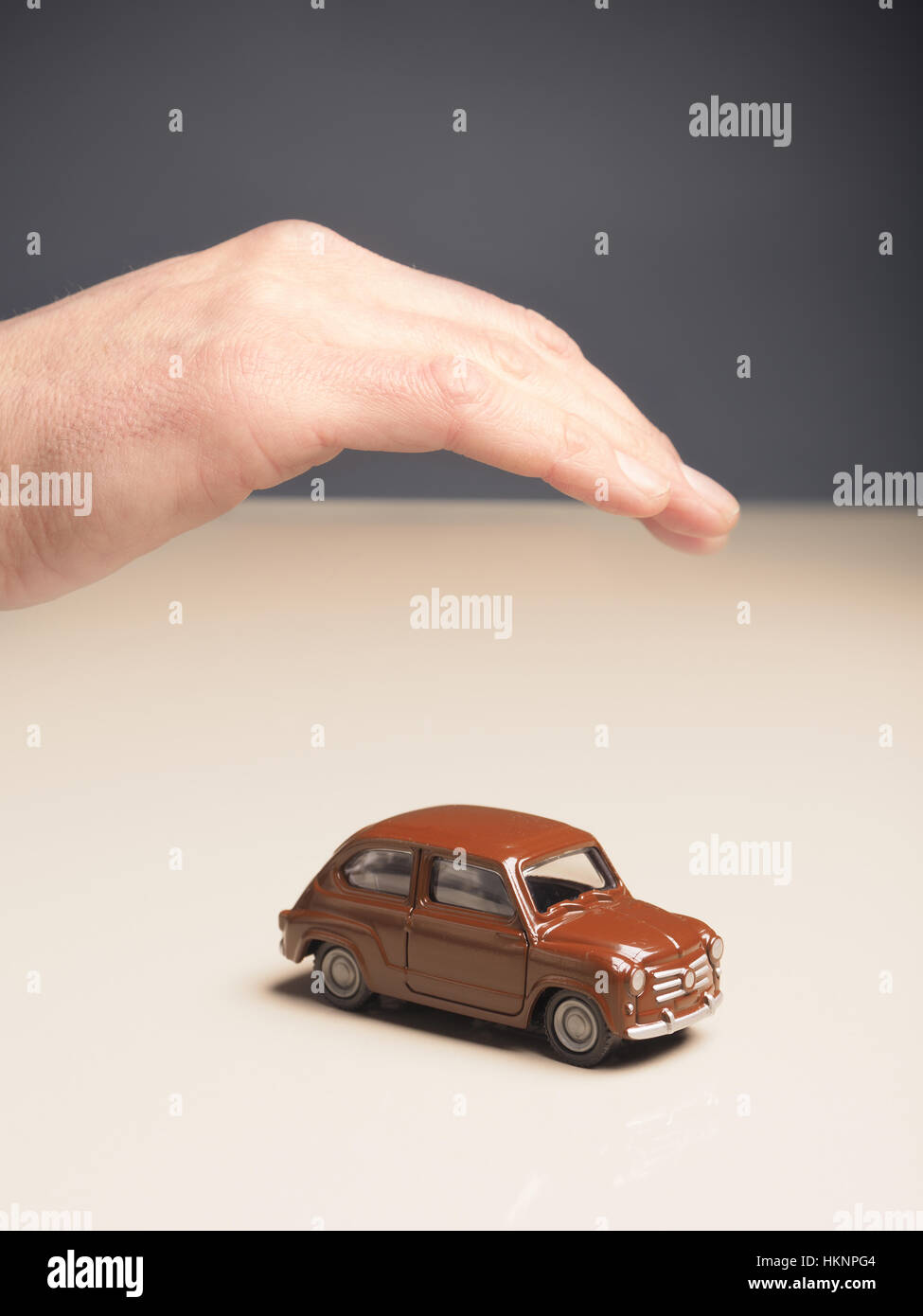 Hand protecting a classic car , safety concept image Stock Photo - Alamy