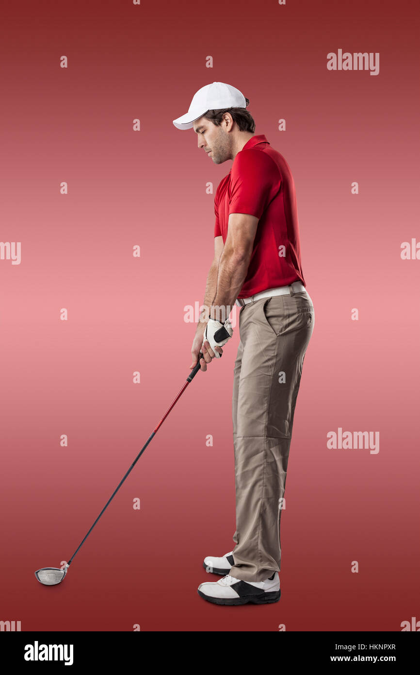 Golf Player in a red shirt taking a swing, on a red Background Stock ...