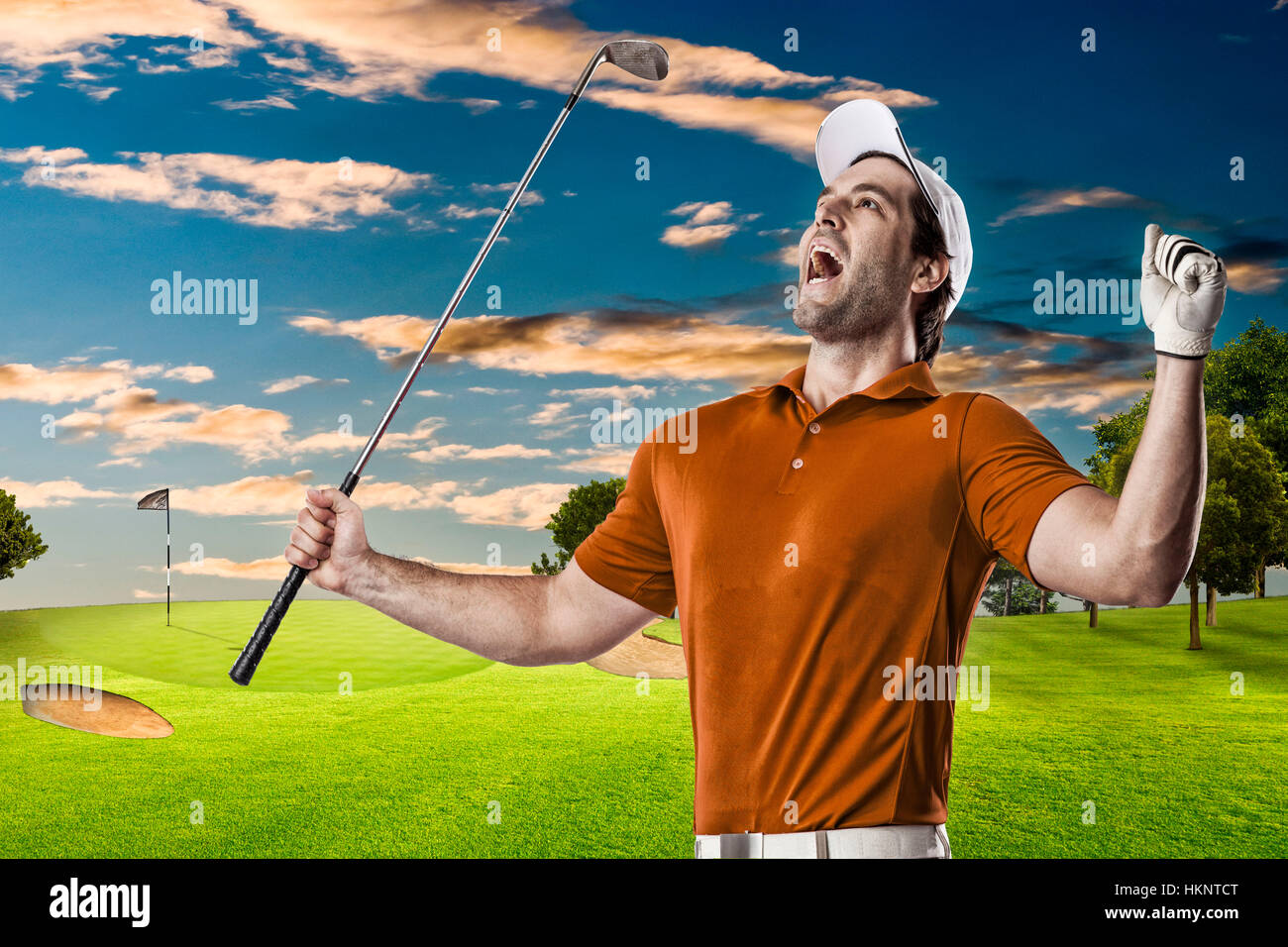 Golf Player in a orange shirt celebrating, on a golf course Stock Photo ...