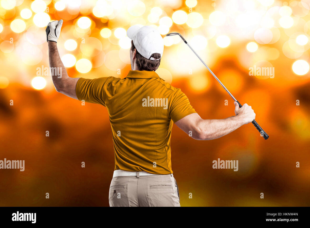 Golf Player in a orange shirt celebrating, on a orange lights ...