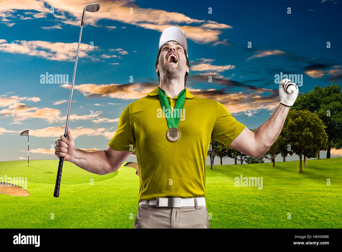 Golf Player in a yellow shirt celebrating with a golden medal, on a ...