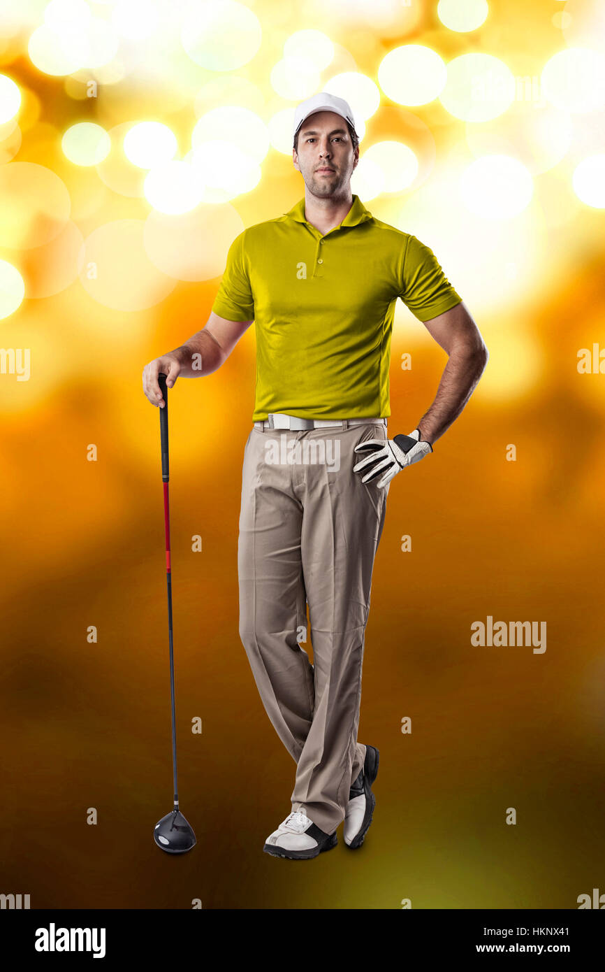 Golf Player in a yellow shirt standing on a yellow lights Background ...