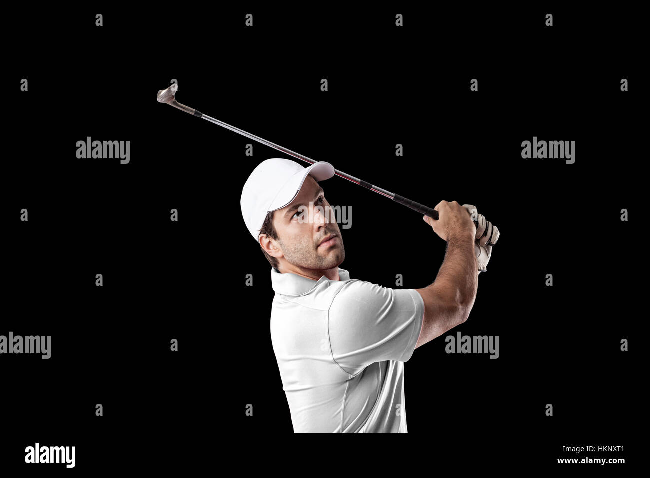 Golf Player in a white shirt taking a swing, on a black Background ...