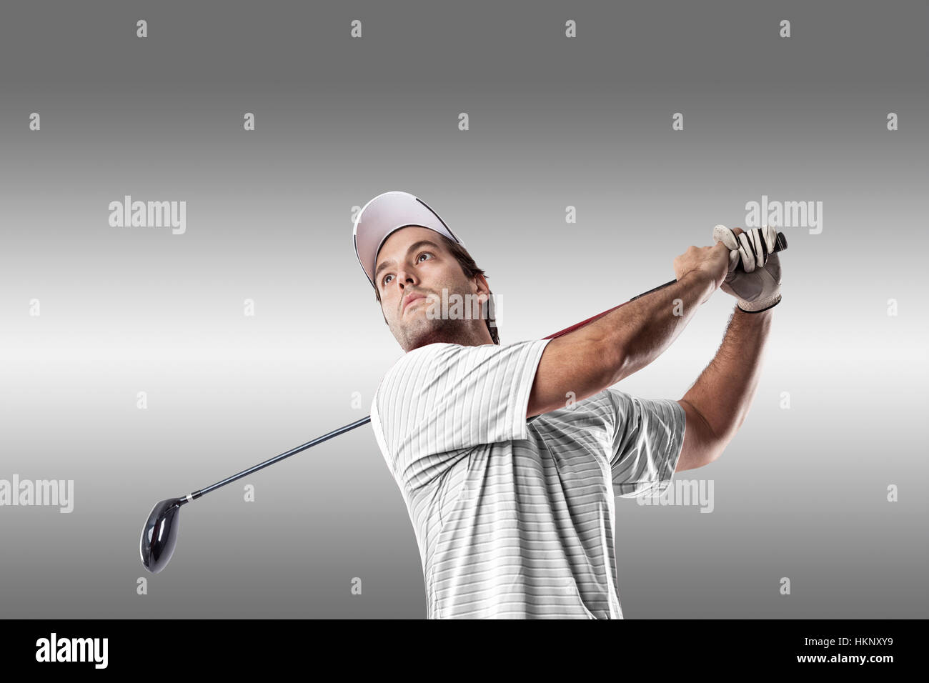 Golf Player in a white shirt taking a swing, on a white Background ...
