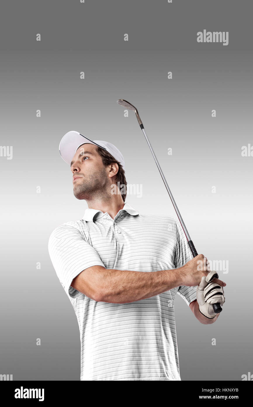 Golf Player in a white shirt taking a swing, on a white Background ...