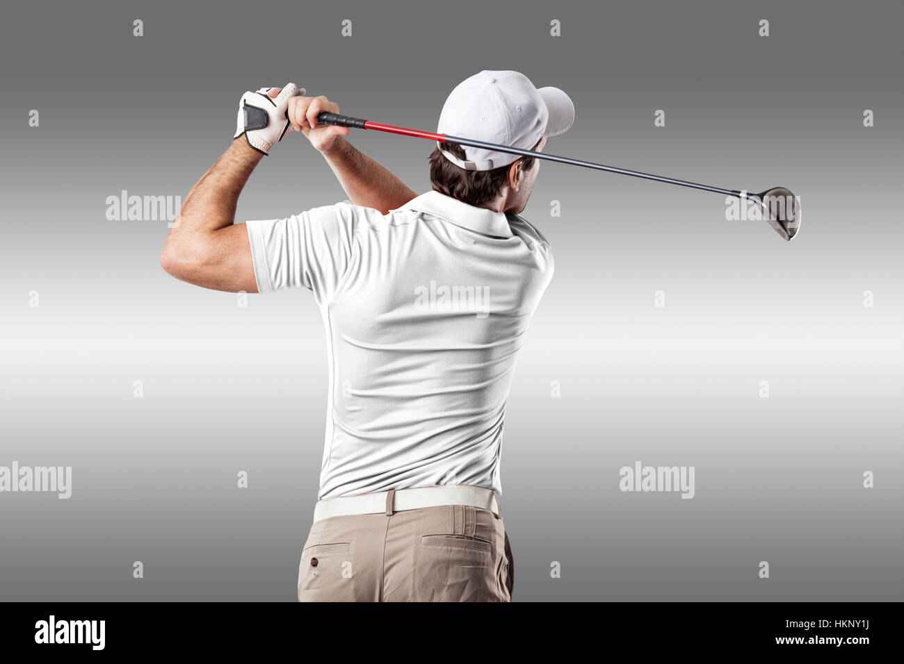 Golf Player in a white shirt taking a swing, on a white Background ...