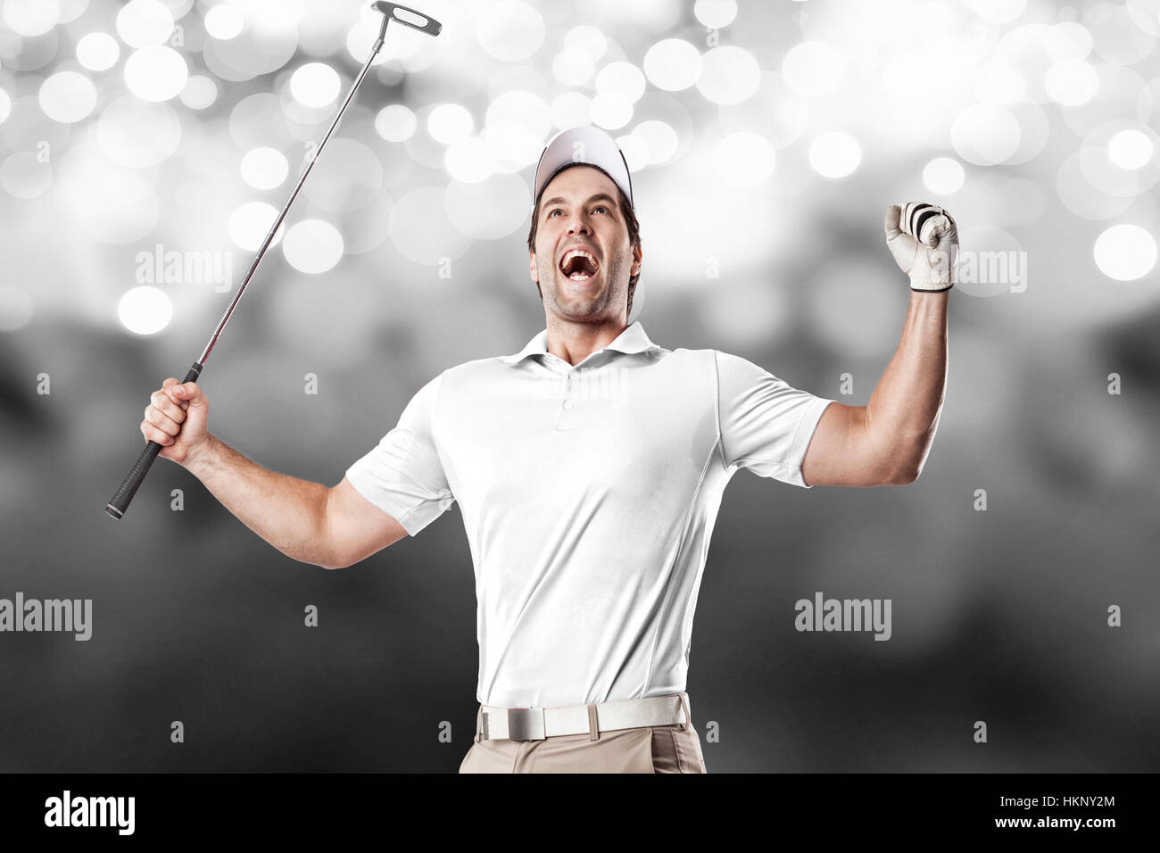 Golf Player in a white shirt celebrating, on a white lights Background ...