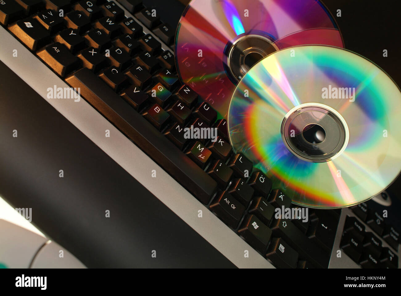 Cd romes on computer keyboard Stock Photo - Alamy