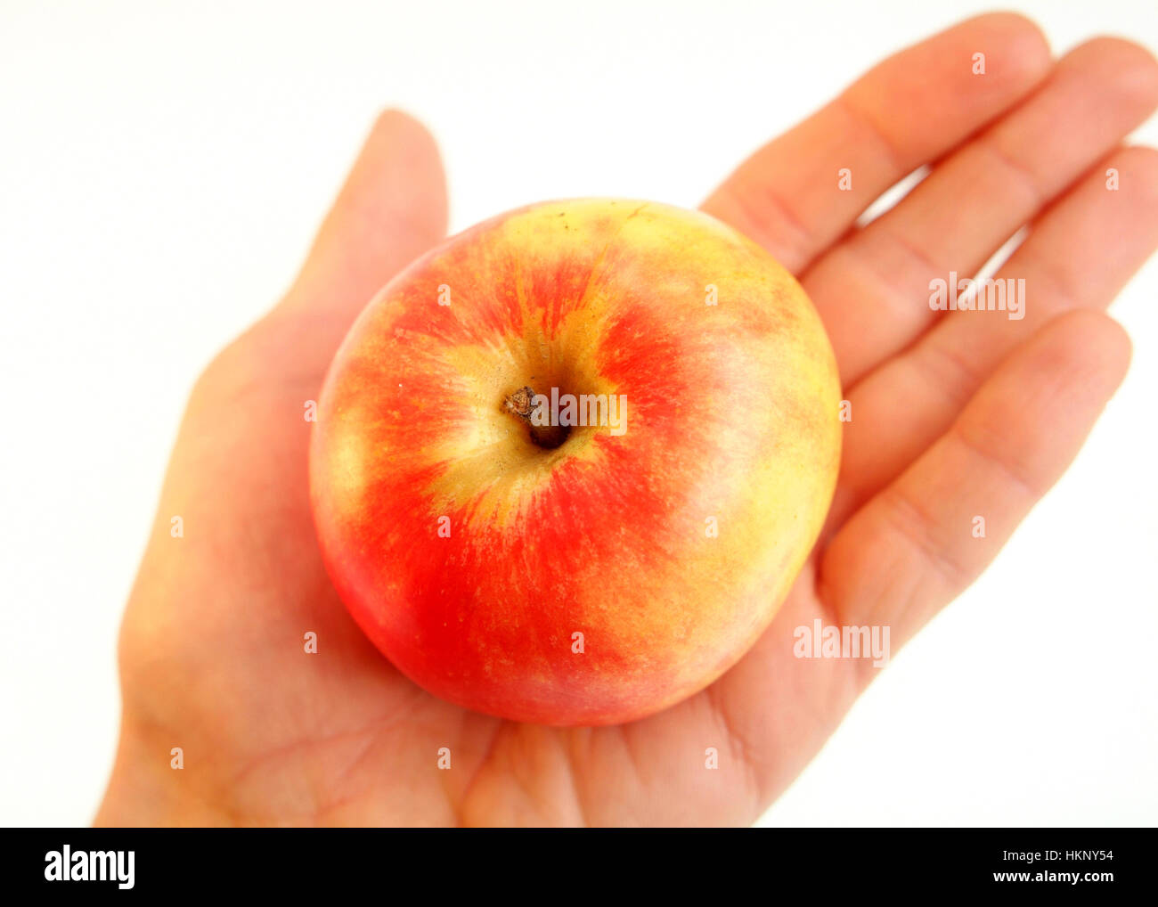 Apple in hand Stock Photo - Alamy