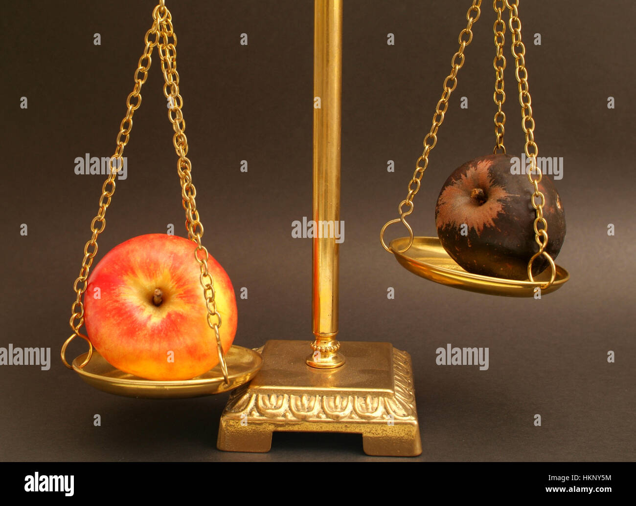 Red and rotten apple on a scale Stock Photo - Alamy
