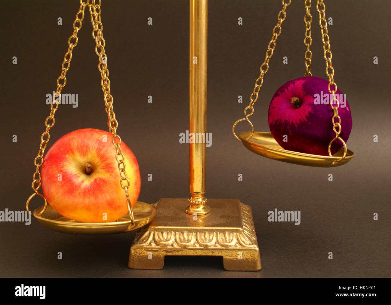 Biological apple contra genetically modified apple Stock Photo - Alamy