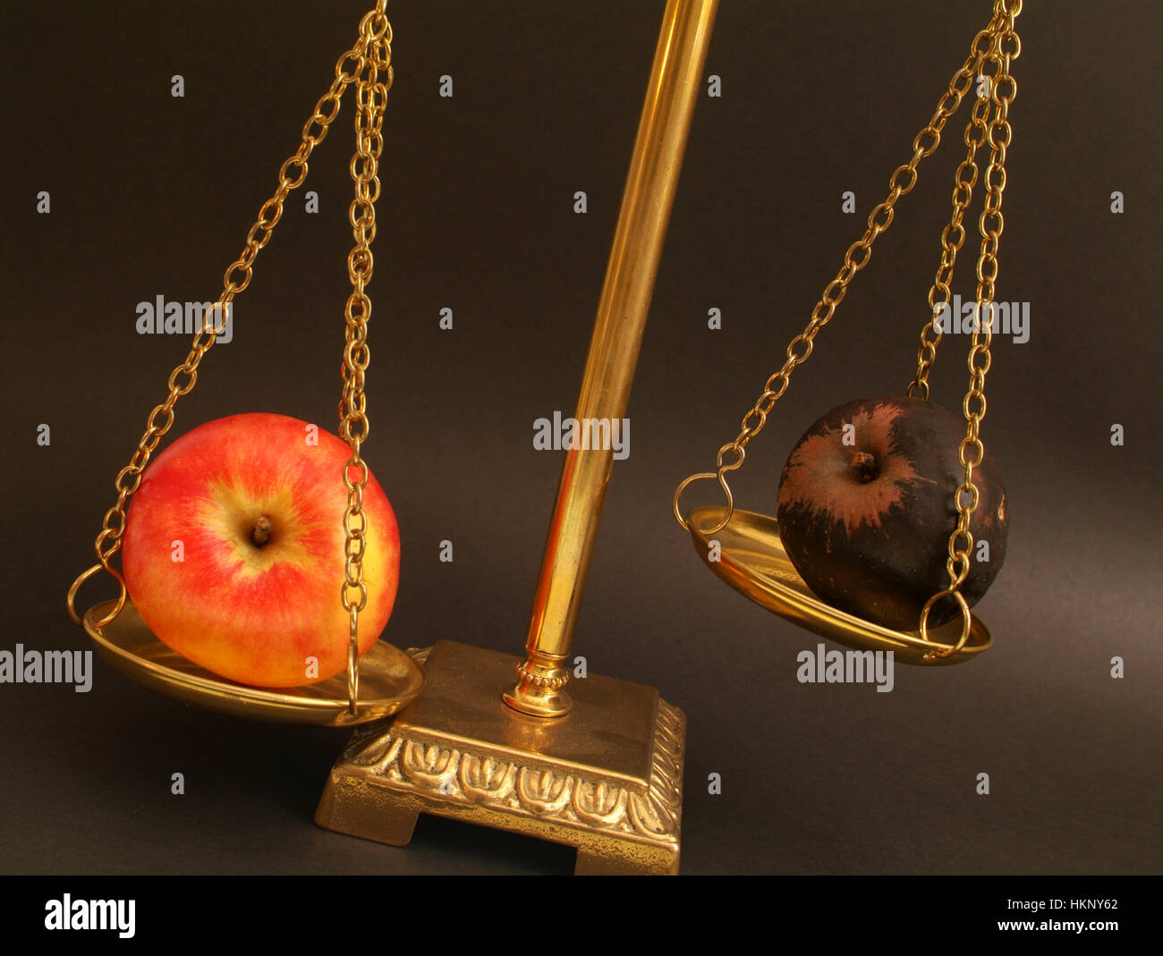 Red and rotten apple on a scale Stock Photo - Alamy