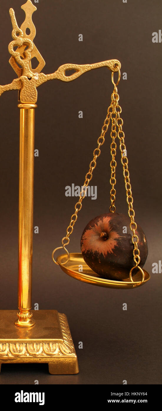 Rotten apple on scale Stock Photo - Alamy