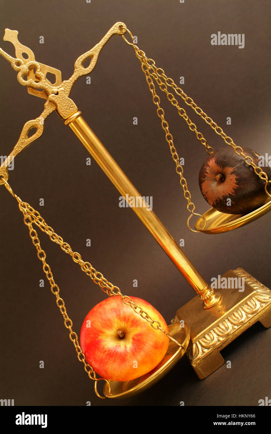 Red and rotten apple on a scale Stock Photo - Alamy