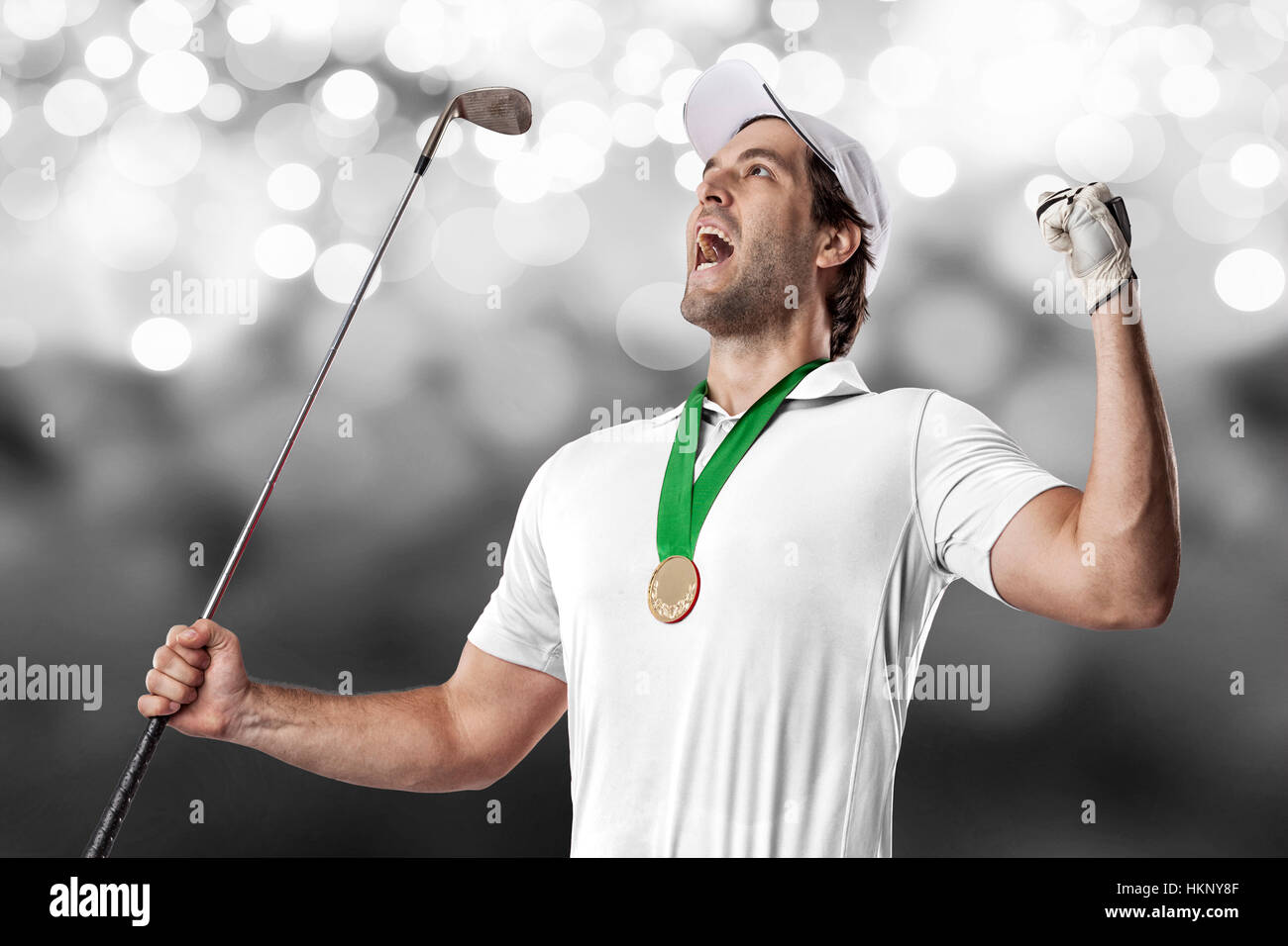 Golf Player in a white shirt celebrating with a golden medal, on a ...