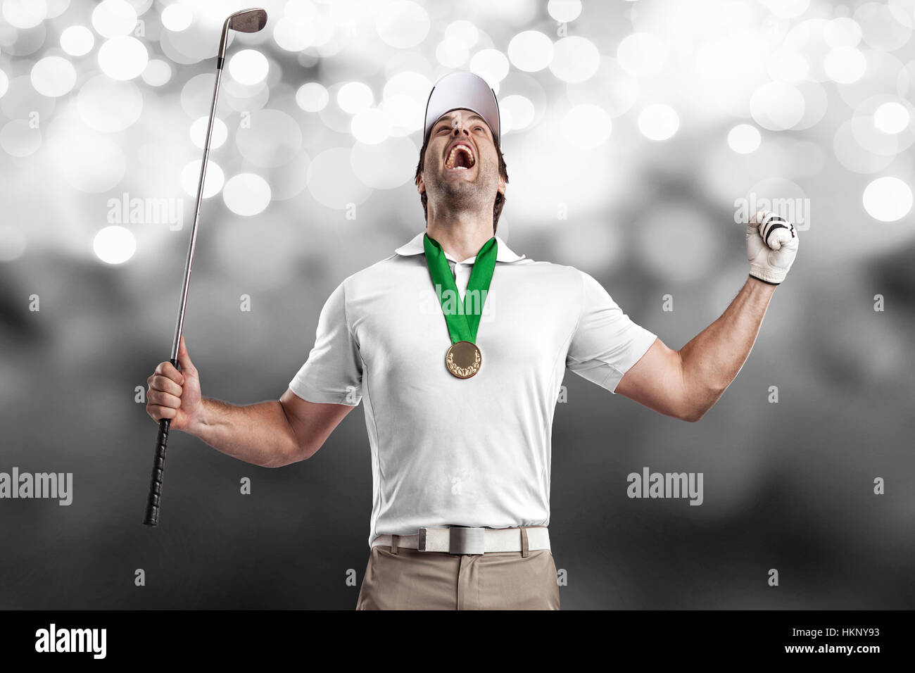 Golf Player in a white shirt celebrating with a golden medal, on a ...