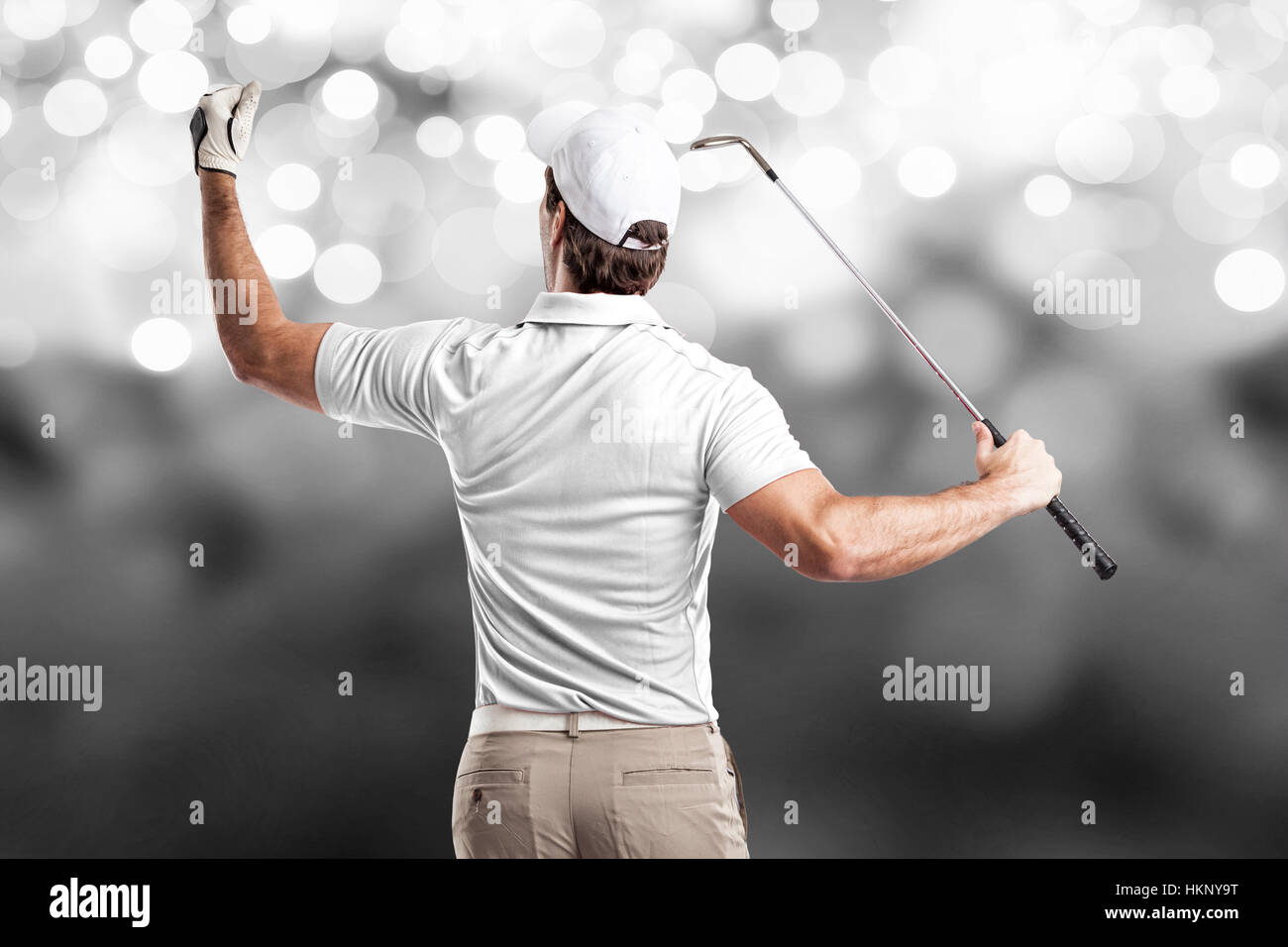 Golf Player in a white shirt celebrating, on a white lights Background ...