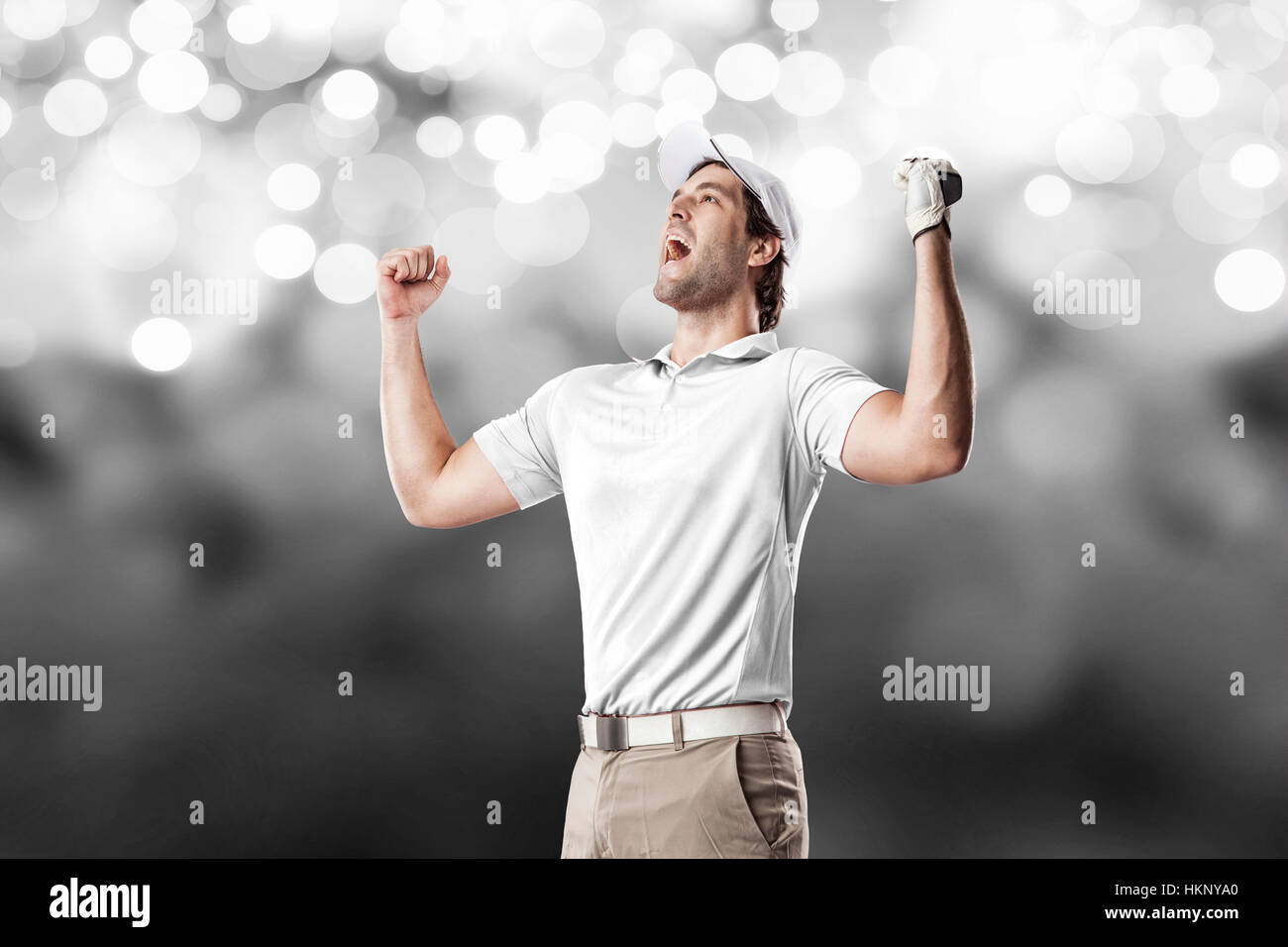 Golf Player in a white shirt celebrating, on a white lights Background ...