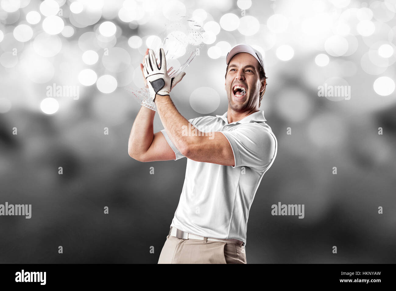 Golf Player in a white shirt celebrating with a glass trophy in his ...