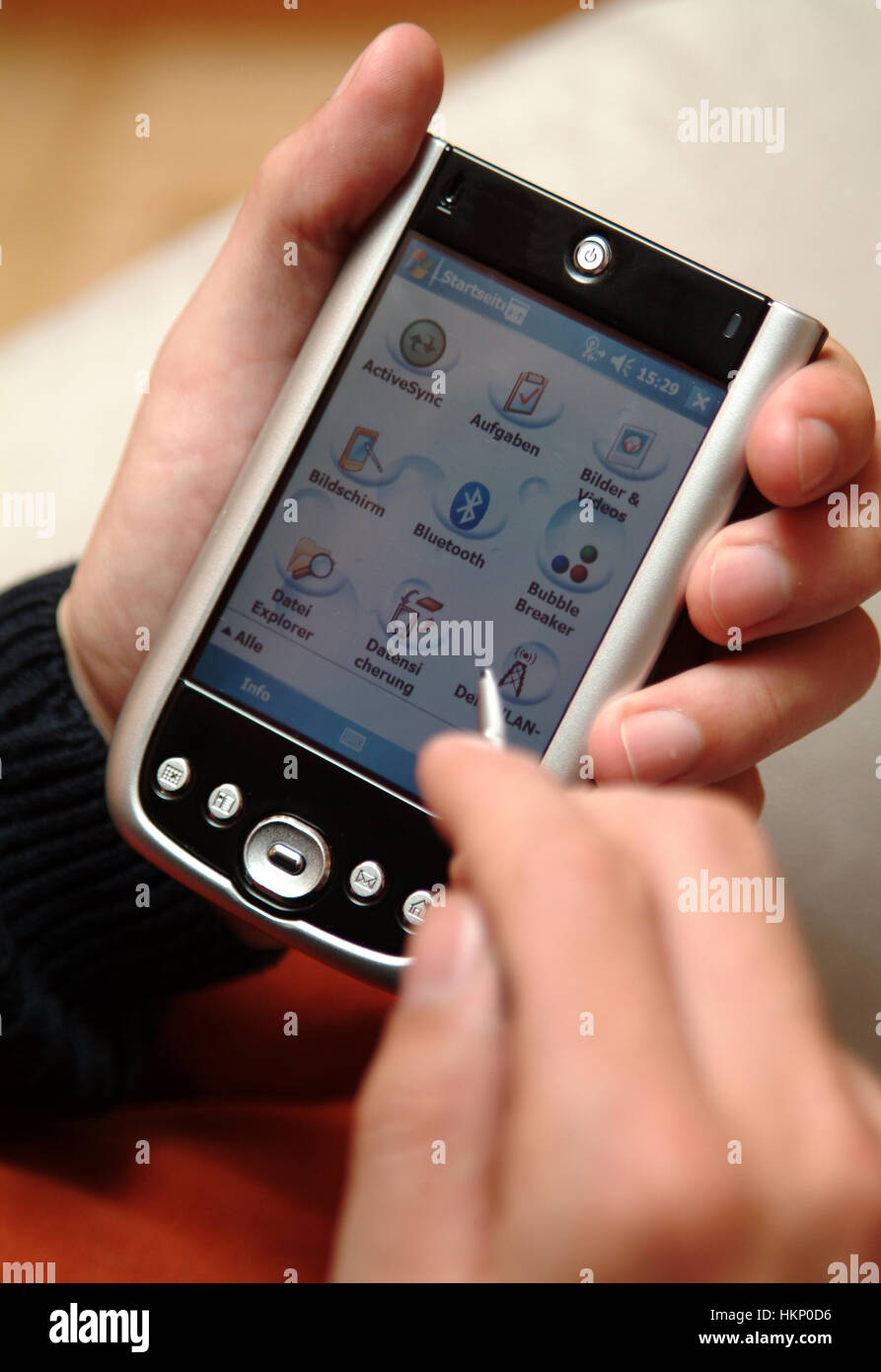 Working on a pda Stock Photo - Alamy