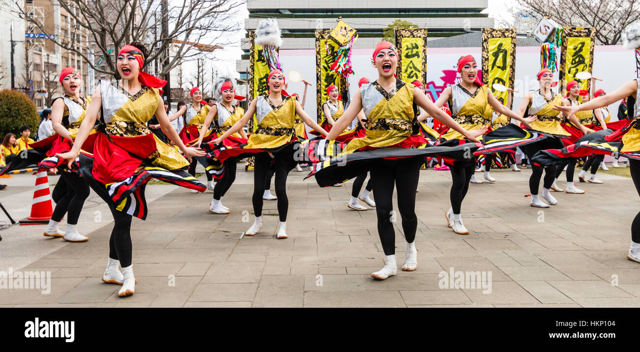 Japanese Yosakoi dance festival. Young women team, in black, gold and ...