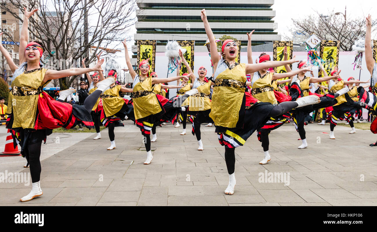 Japanese Yosakoi dance festival. Young women team, in black, gold and ...