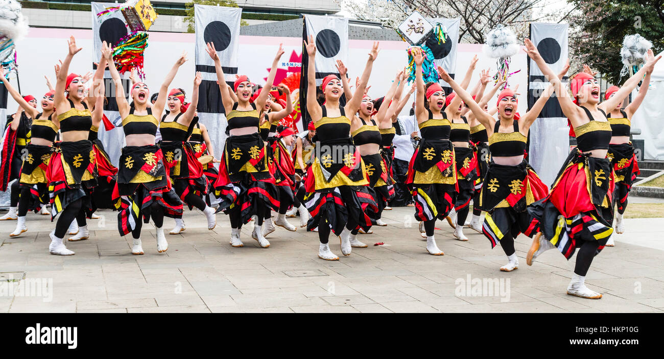 Japanese Yosakoi dance festival. Young women team, in black, gold and ...