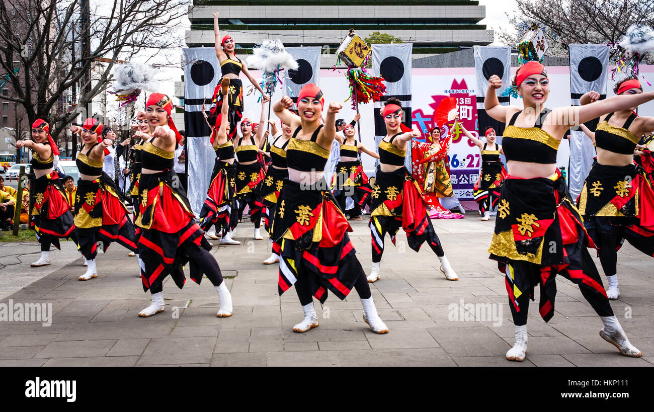 Japanese Yosakoi dance festival. Young women team, in black, gold and ...