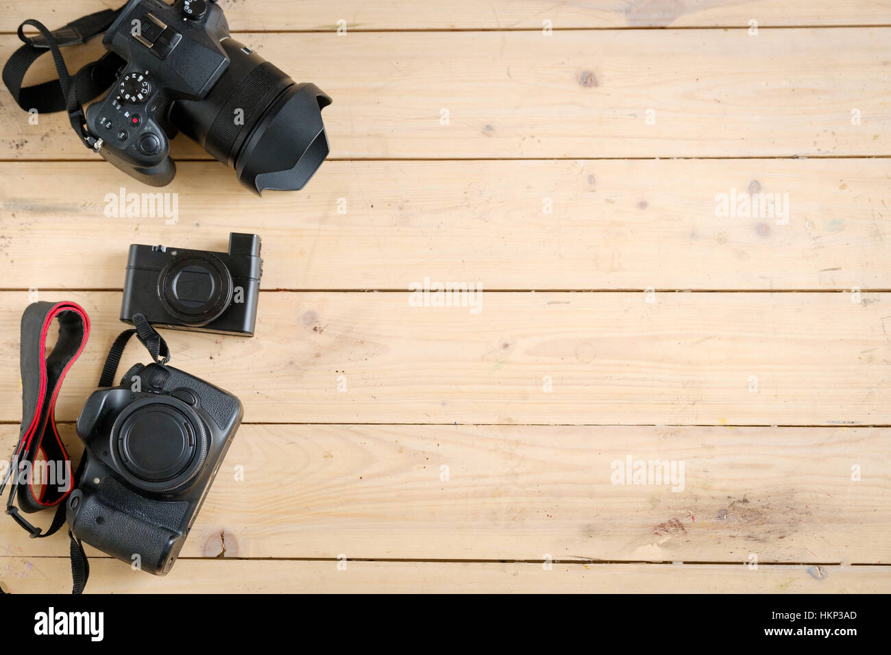 Digital cameras on the wooden table Stock Photo - Alamy
