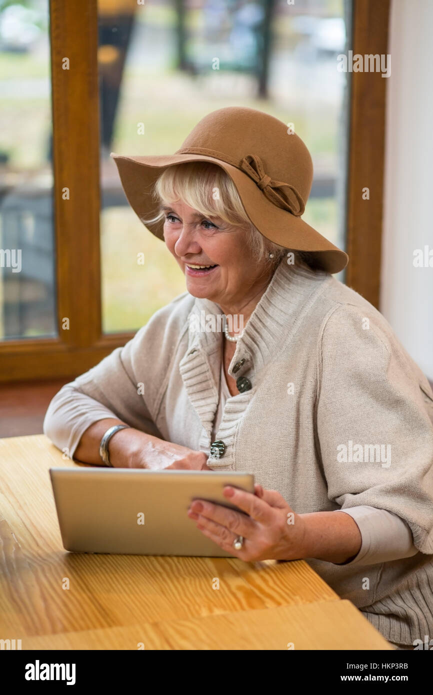 Elderly woman with a tablet Stock Photo - Alamy