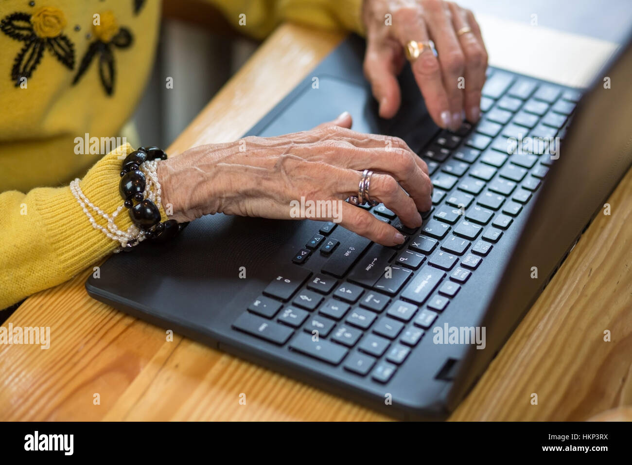 Old hands and laptop Stock Photo - Alamy